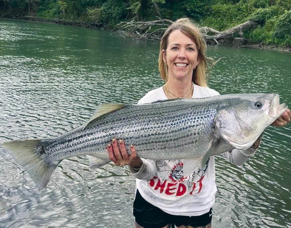 Christy Rhynes catches striped bass - Sequoyah County Times